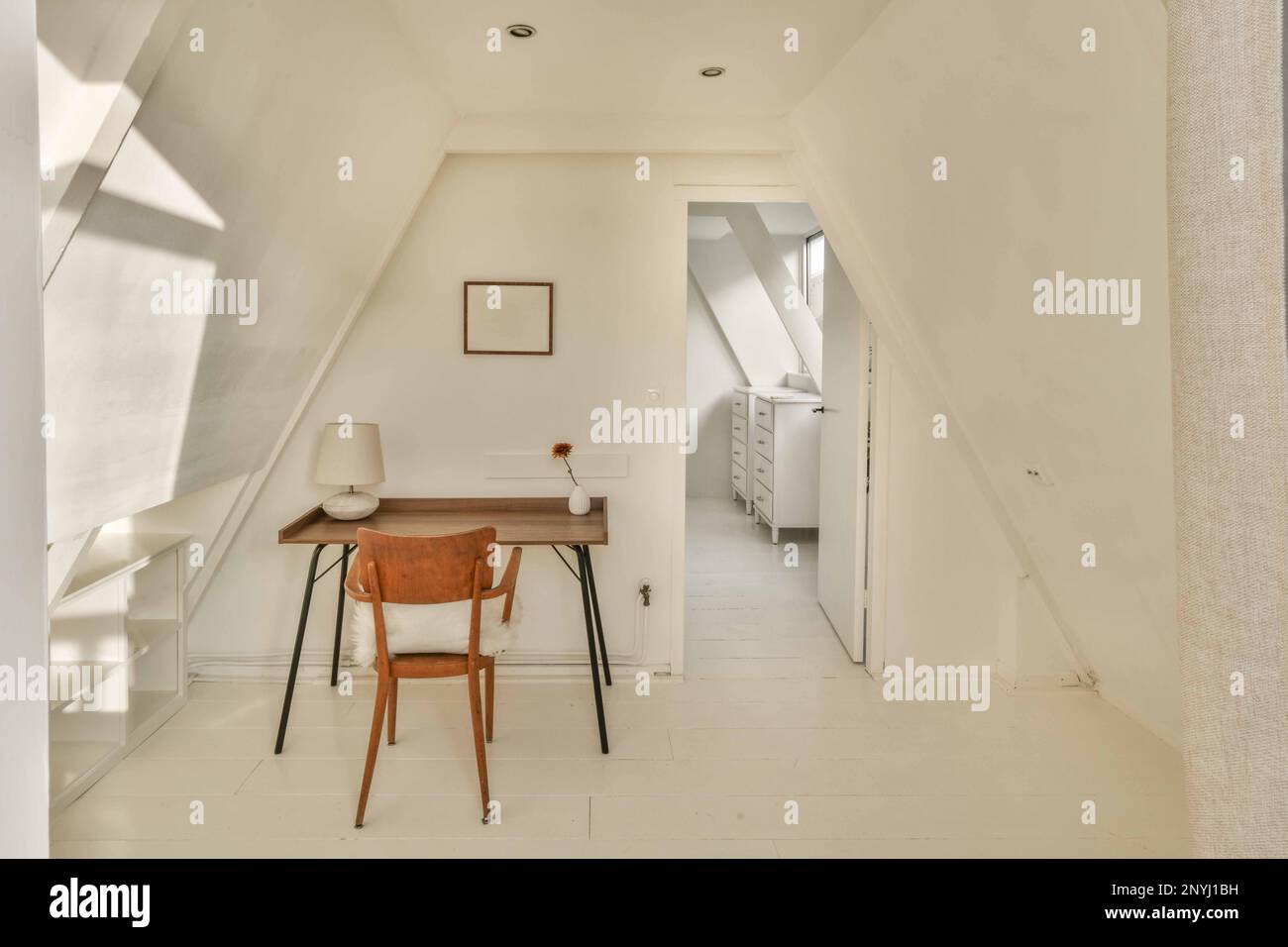 a table and chair in a small room with white walls, flooring and stairs ...