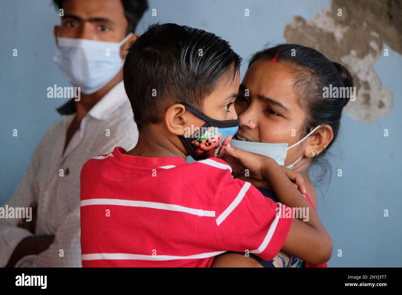 A woman carries her child suffering from Acute Respiratory Infection ...