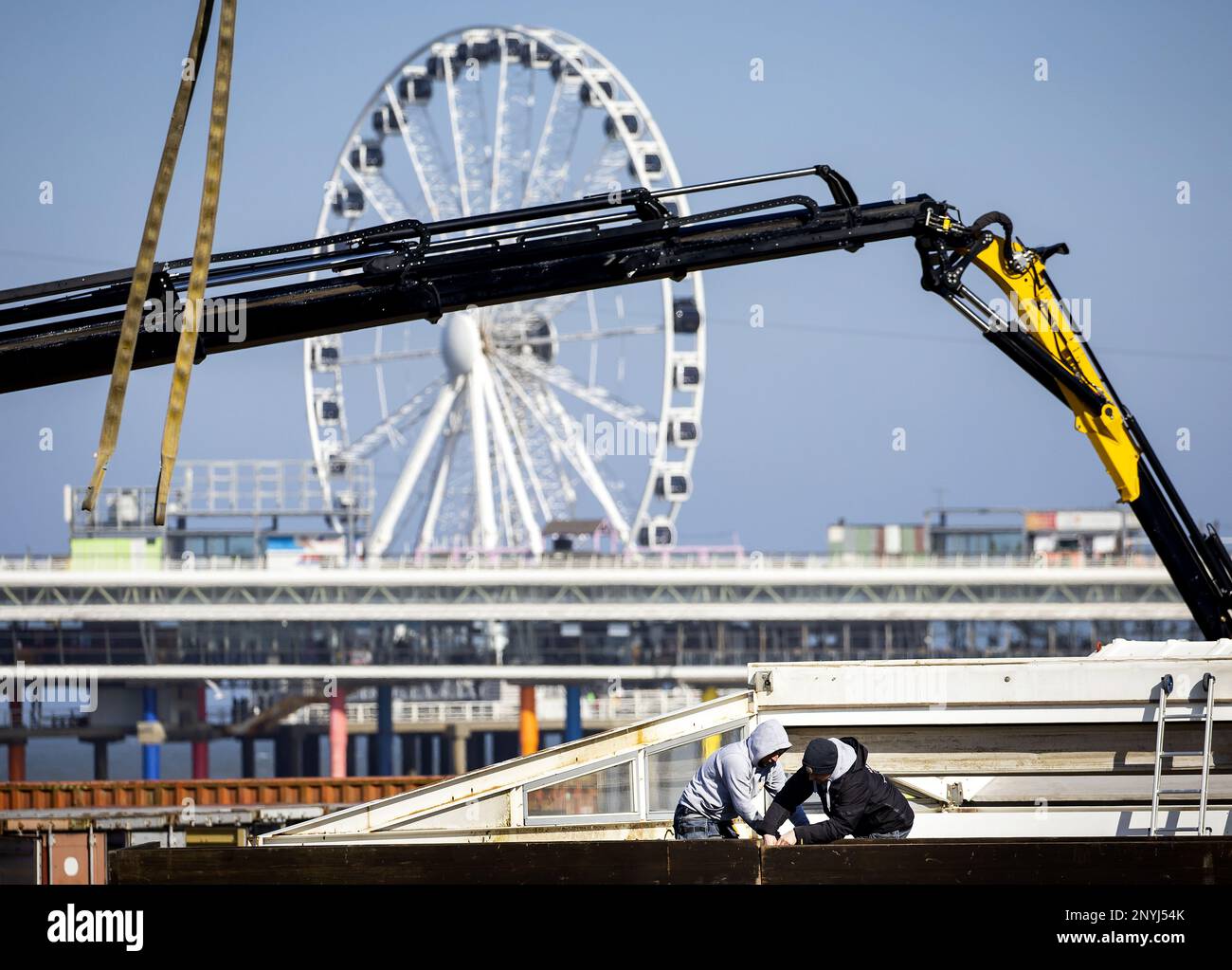 THE HAGUE - Work on the beach of Scheveningen where beach tents are ...
