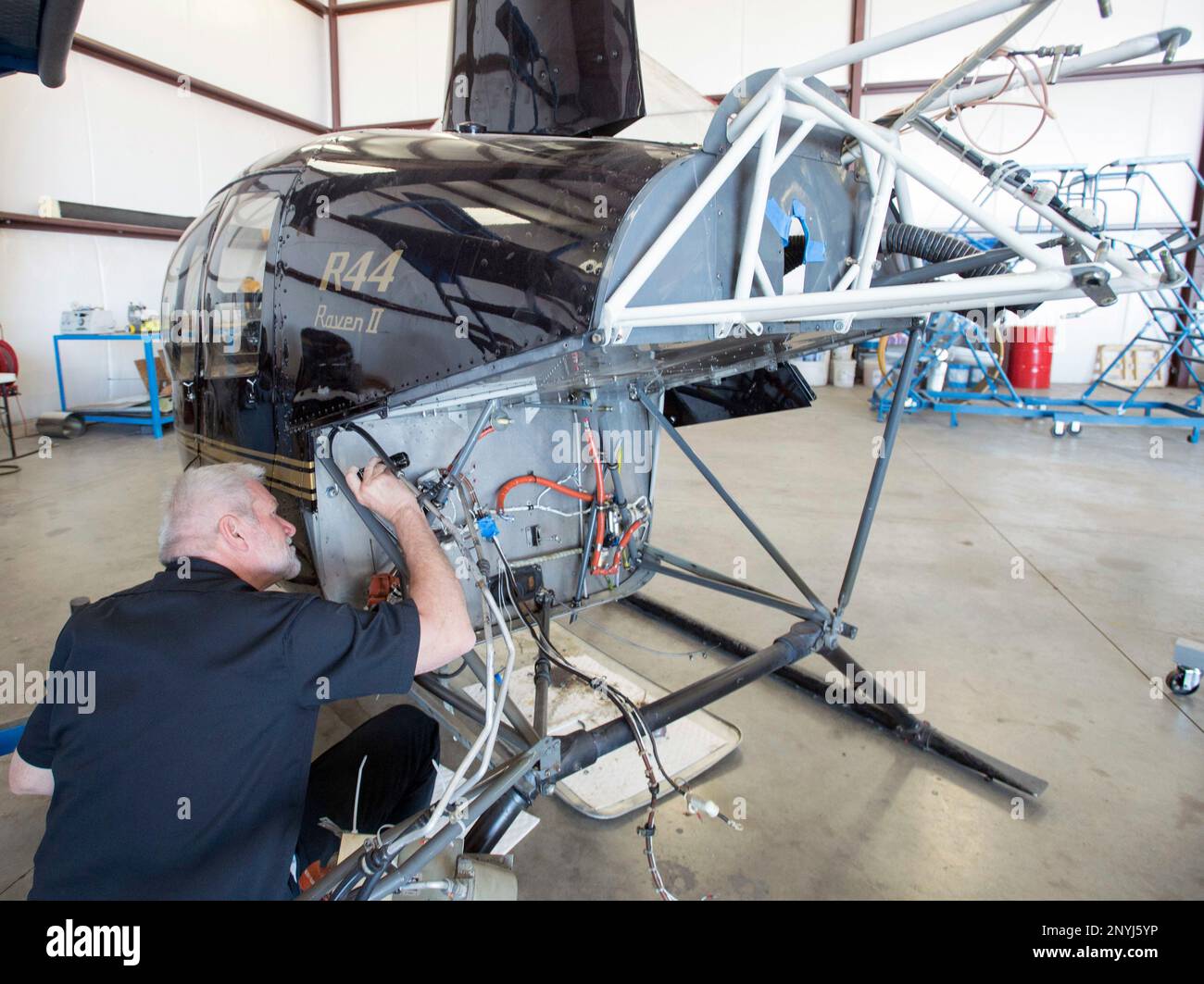 In this June 14, 2017 photo, Willy Robinet inspects an R44 Raven II ...