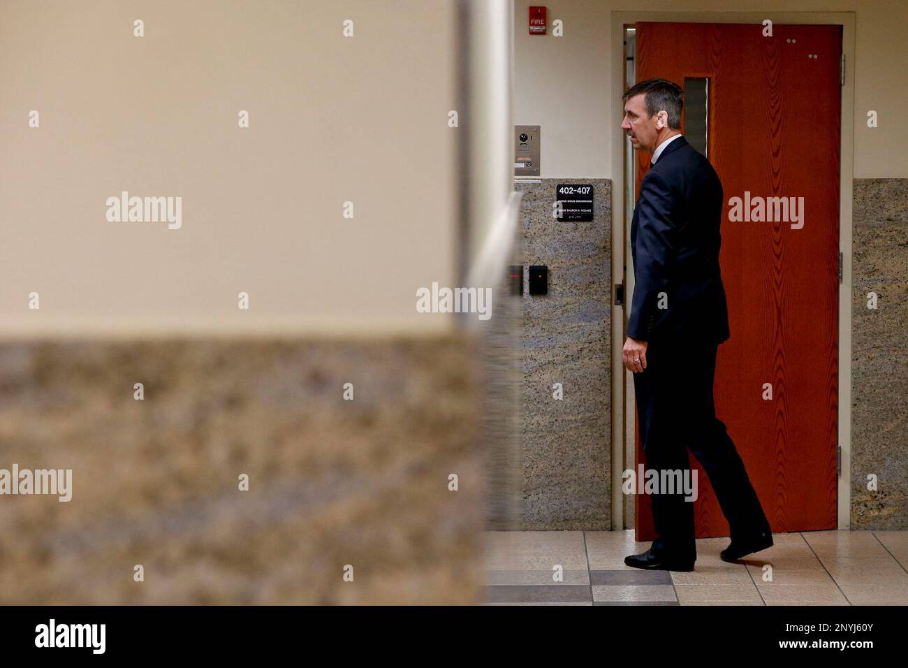 Tulsa District Attorney Steve Kunzweiler walks down a hallway while the ...