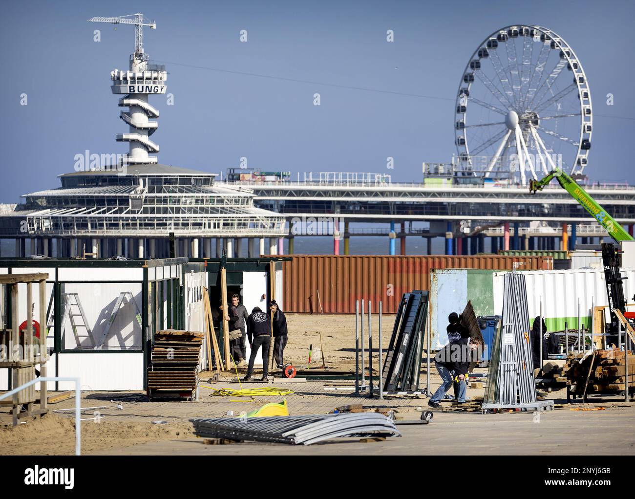 THE HAGUE - Work on the beach of Scheveningen where beach tents are ...