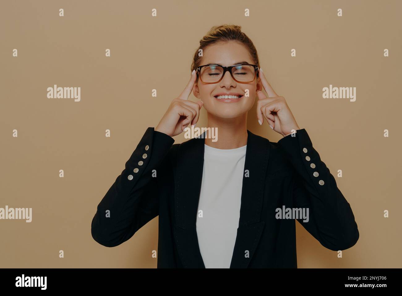 Happy young woman closing eyes and smiling in anticipation for ...