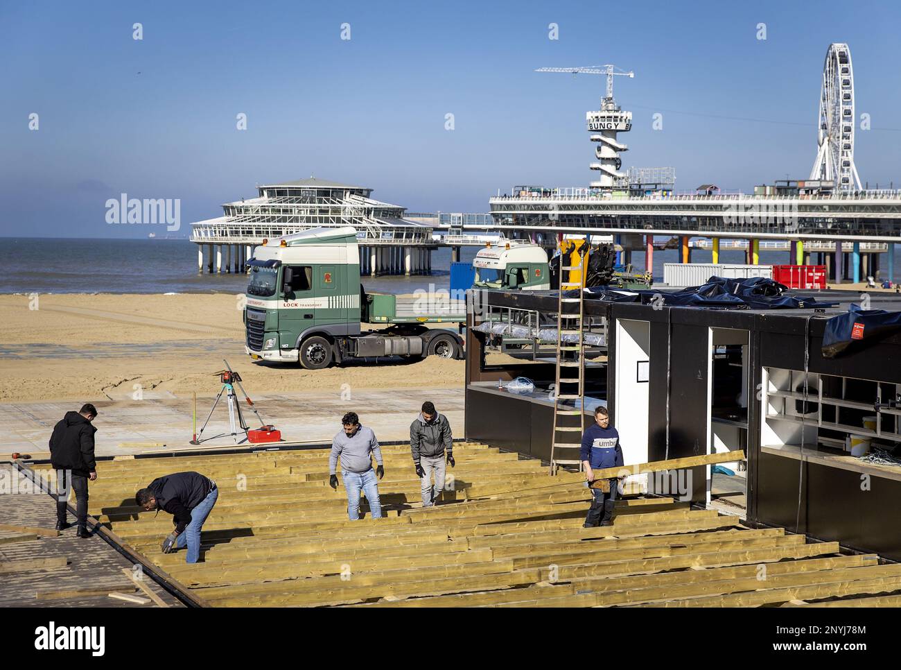 THE HAGUE - Work on the beach of Scheveningen where beach tents are ...