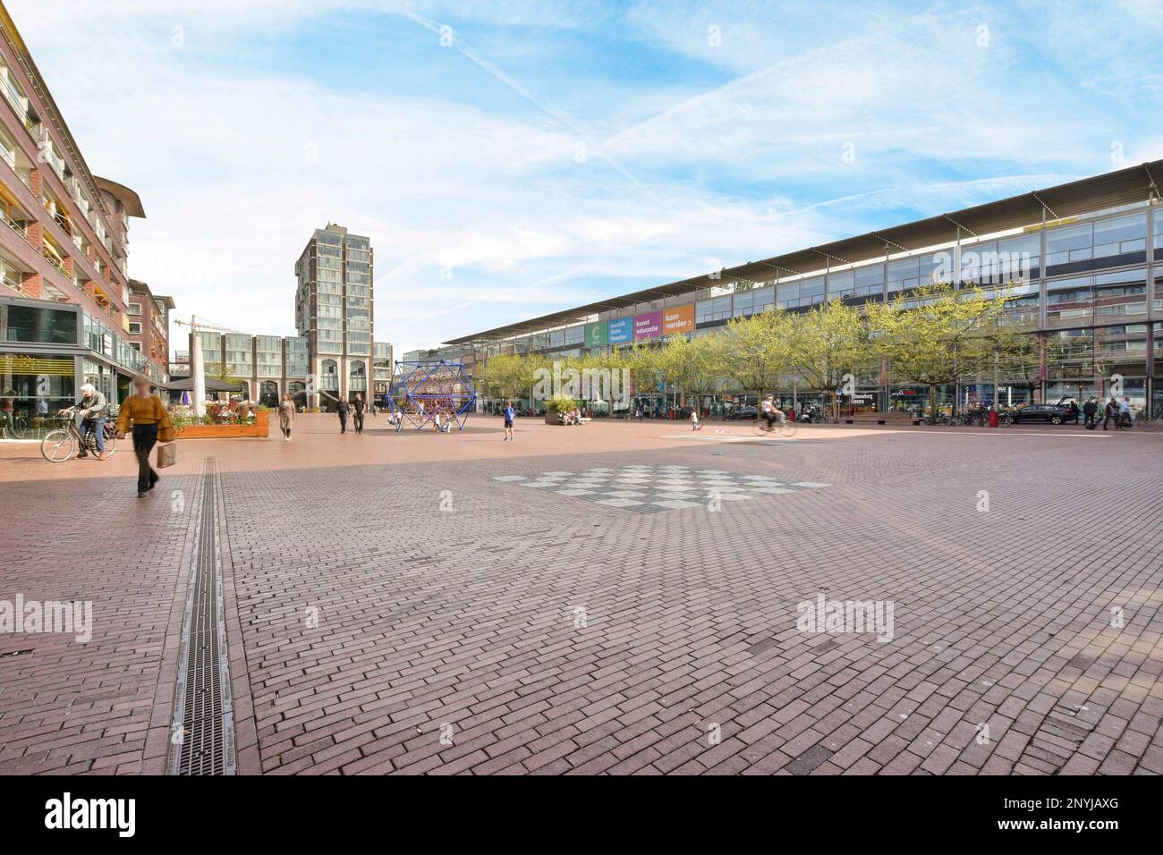 a city square with people walking and sitting on benches in the middle ...