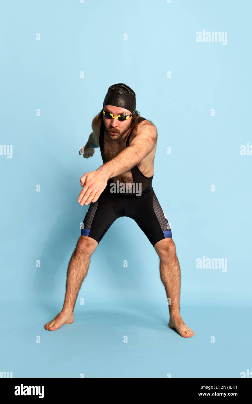 Comic portrait of funny bearded man in swimsuit and swimming cap and ...