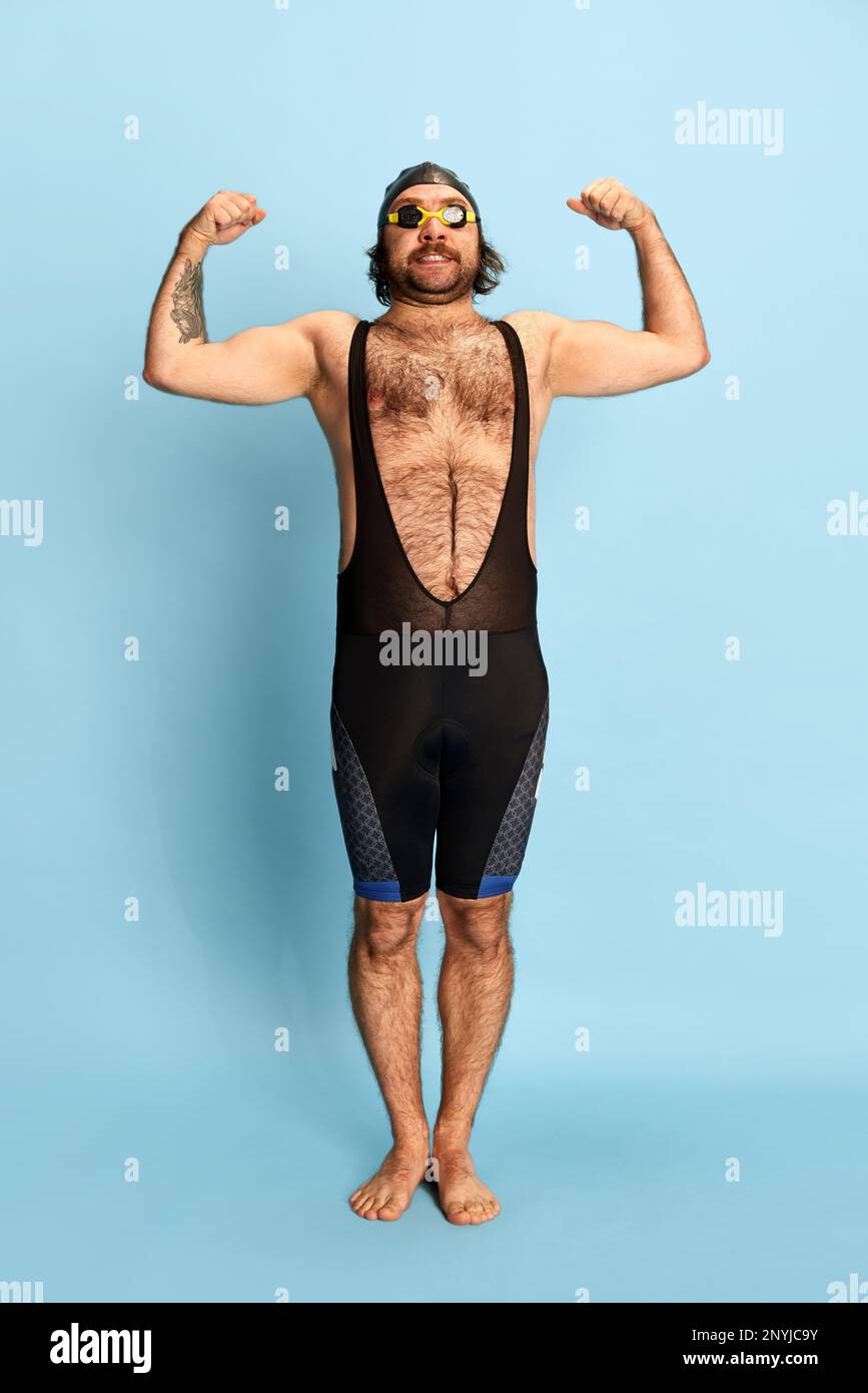 Comic portrait of funny bearded man in swimsuit and swimming cap and ...