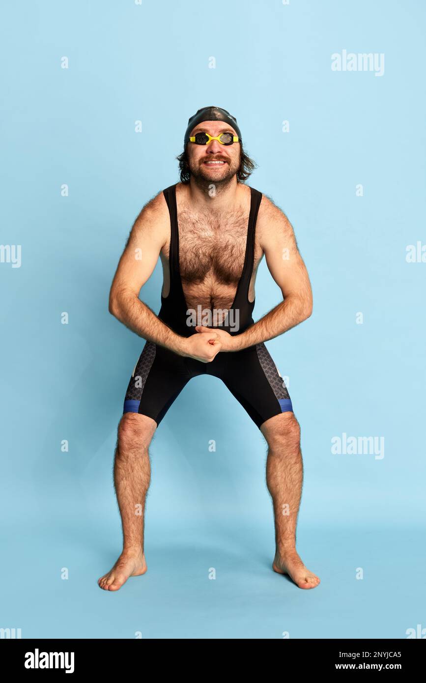 Comic portrait of funny bearded man in swimsuit and swimming cap and ...