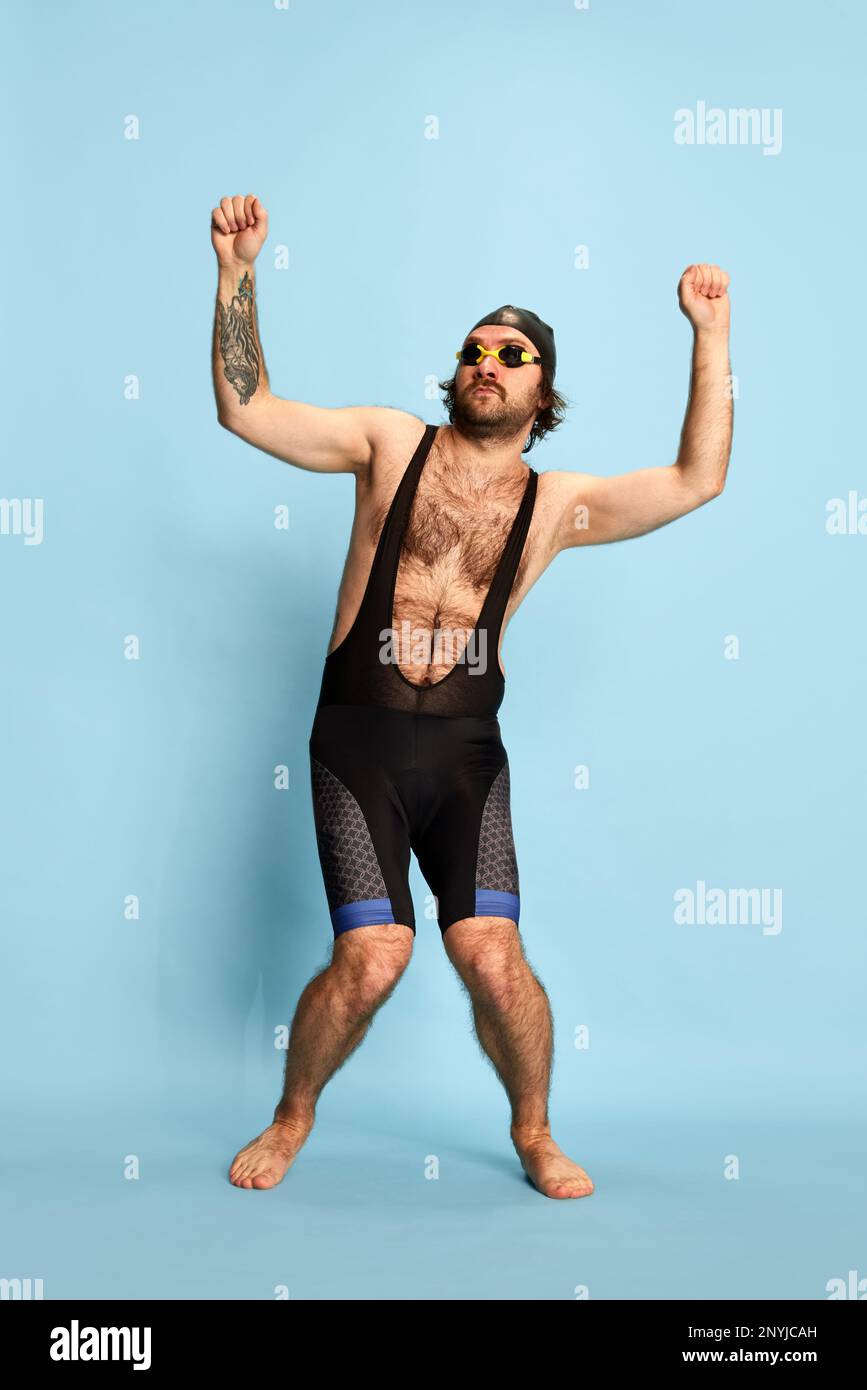 Comic portrait of funny bearded man in swimsuit and swimming cap and ...