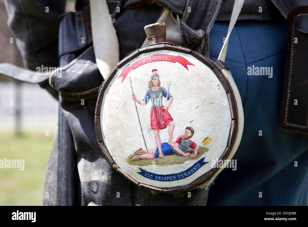 A wooden canteen with the Virginia state seal on it is worn by a re ...