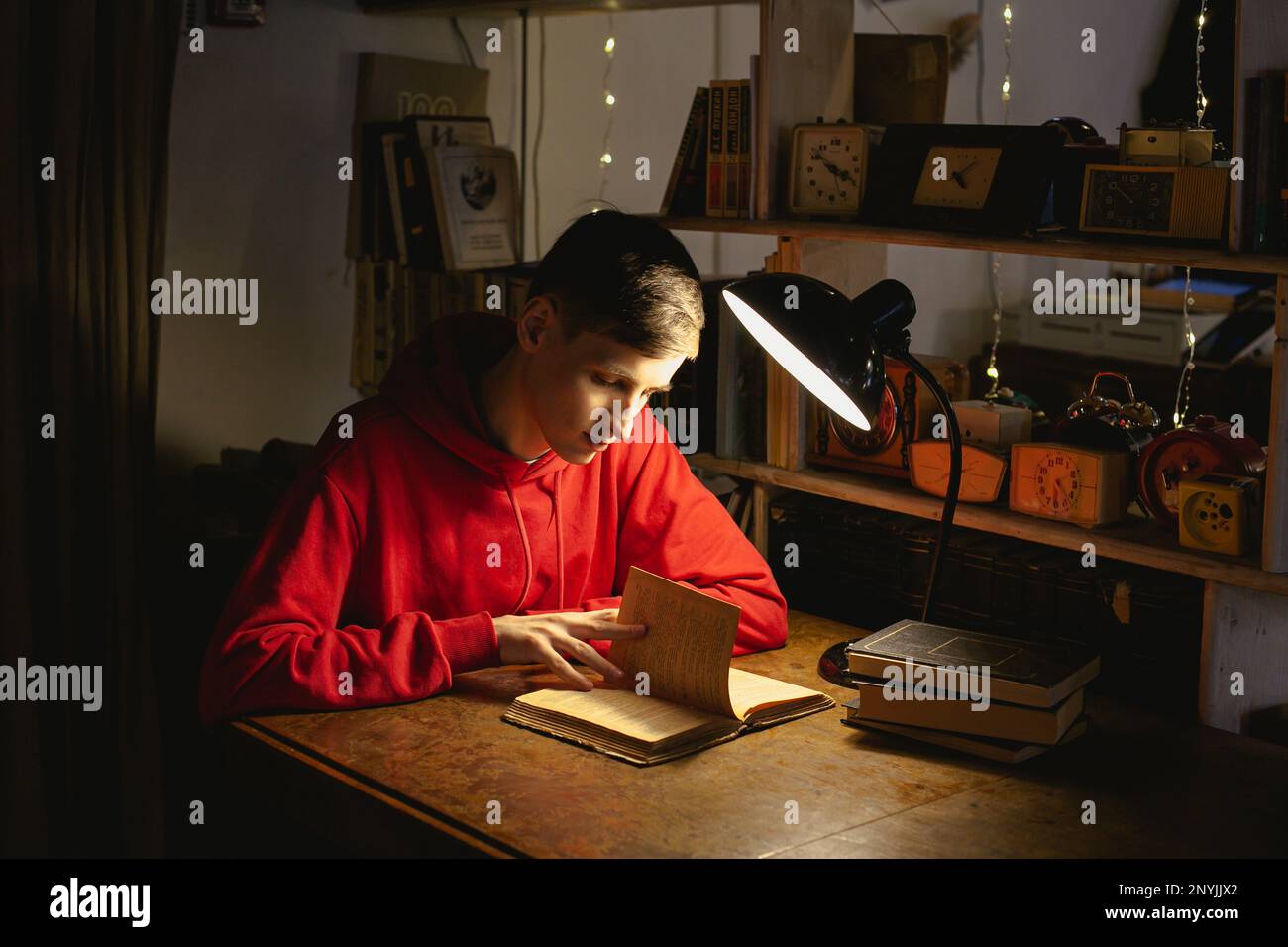 Reading a book under a lamp hi-res stock photography and images - Alamy