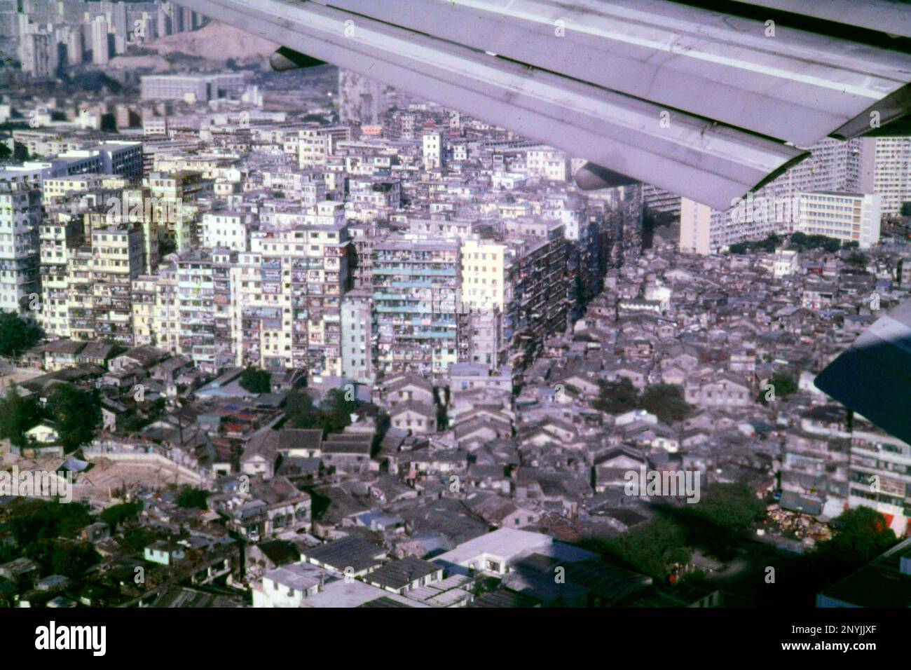 Kowloon Walled City, viewed below an arriving aircraft wing, Kowloon ...