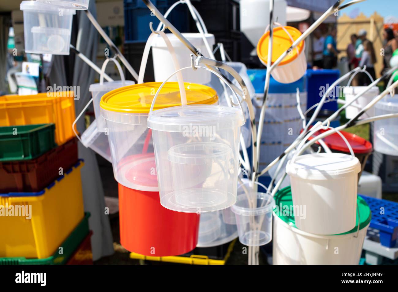 A lot of plastic packaging lies on a wooden floor. Plastic bottles of ...