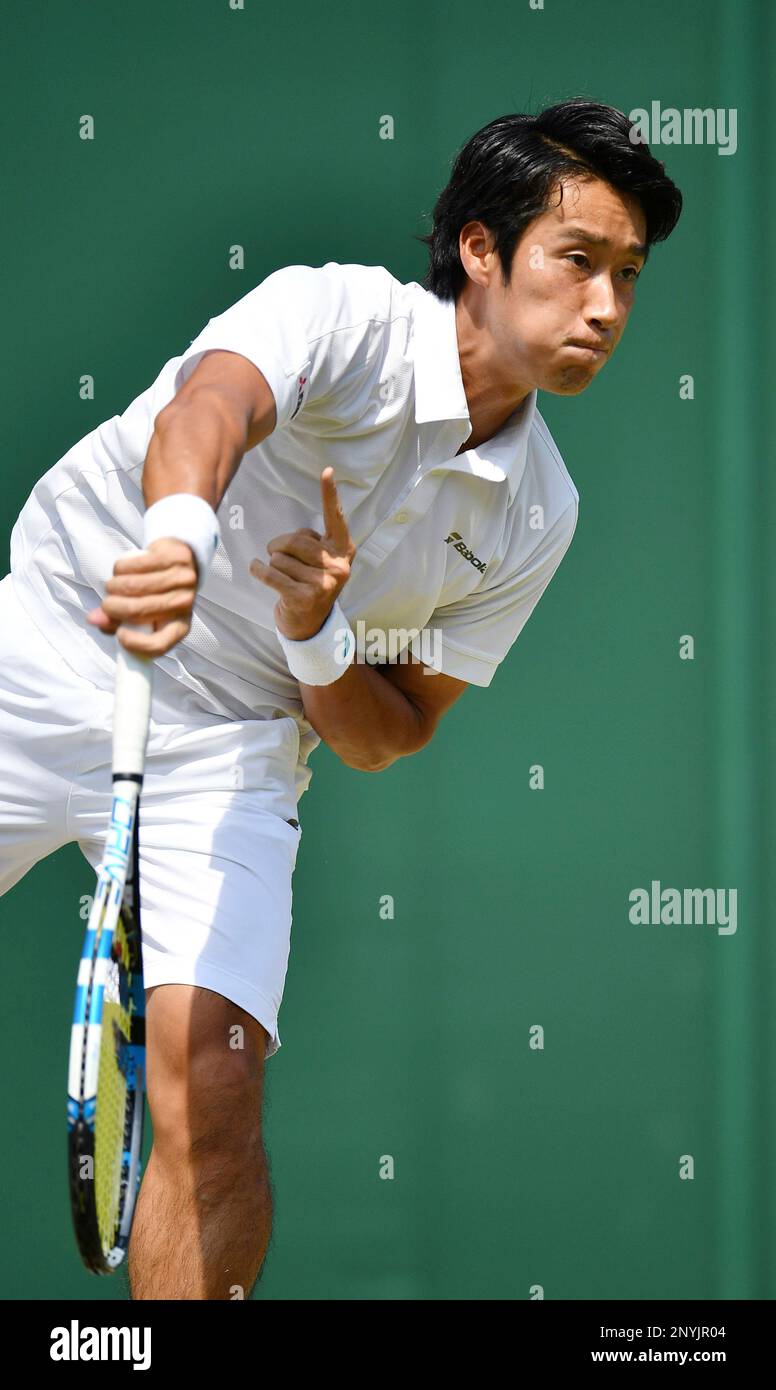 Yuichi Sugita of Japan hits a serve during the second round of the Wimbledon tennis tournament ...