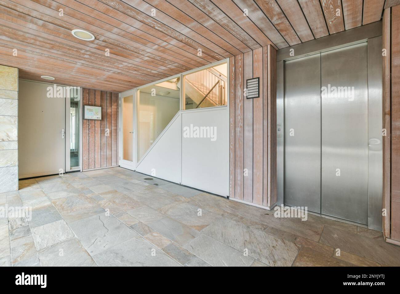 an empty room with two elevators in the middle and one on the other ...