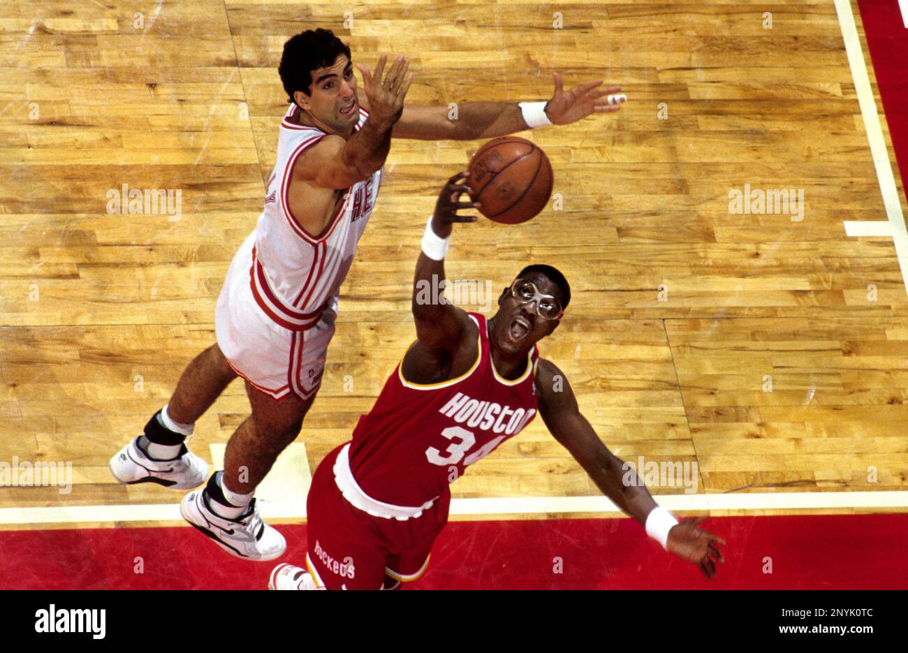 Houston Rockets center Hakeem Olajuwon (34) grabs a rebound against the ...