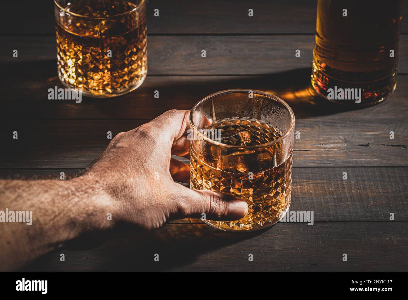 Hand Holding Whiskey Glass