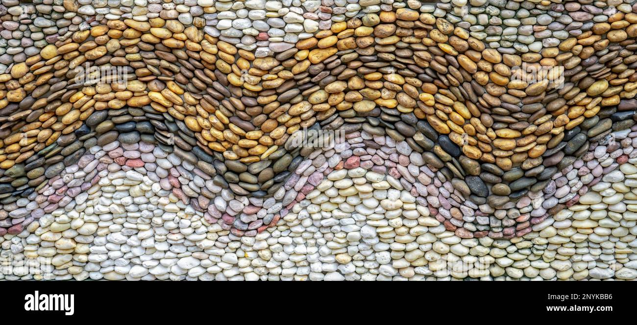 Pebbles stone wall texture background. Pebbles mosaic. Wave pattern ...