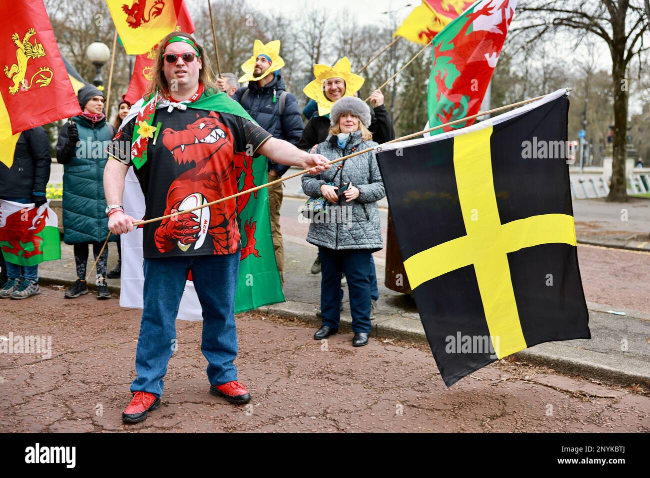 Cardiff, UK. 01st Mar, 2023. Parade participants hold yellow and black ...