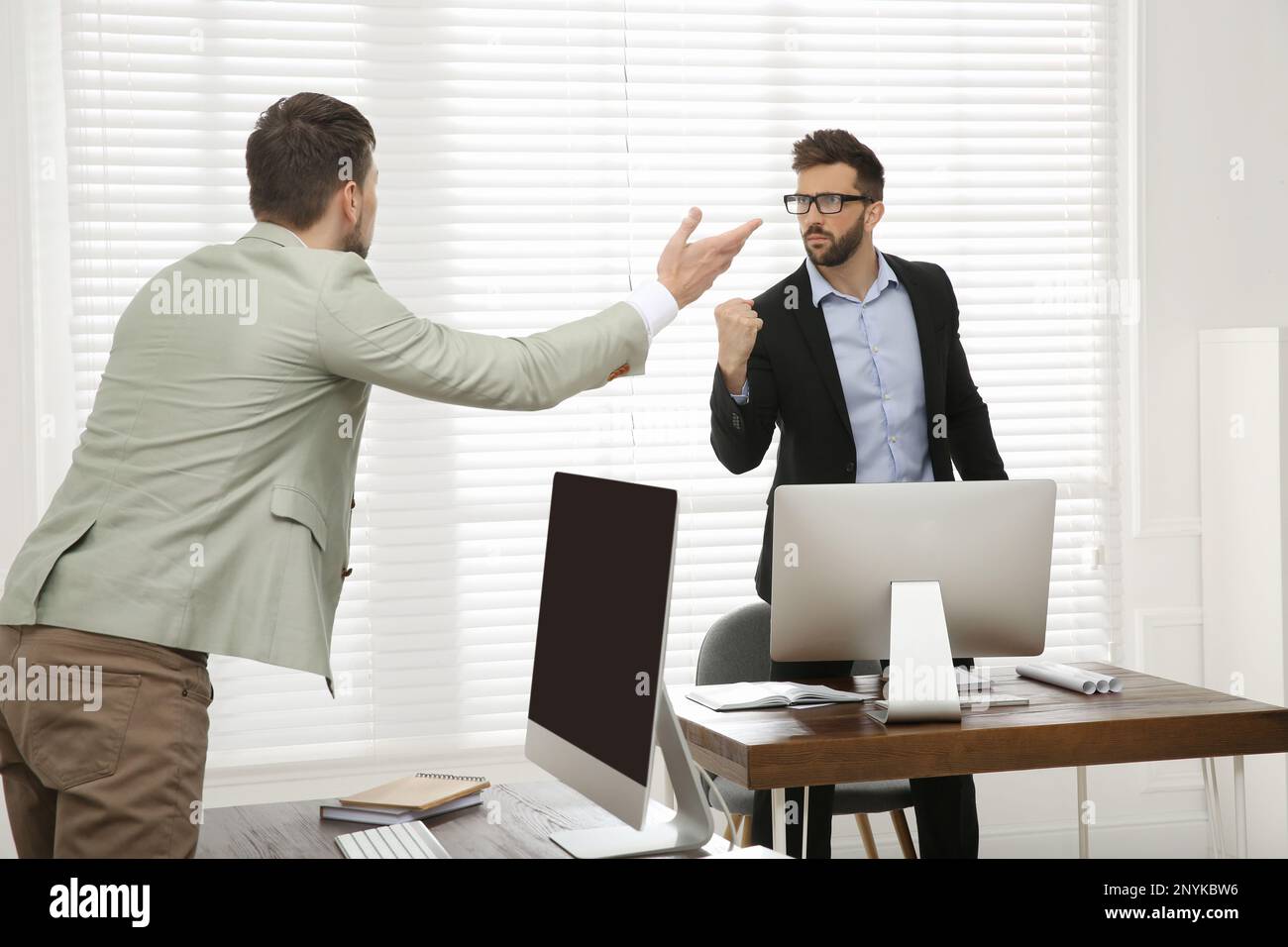 Emotional colleagues arguing in office. Toxic work environment Stock ...