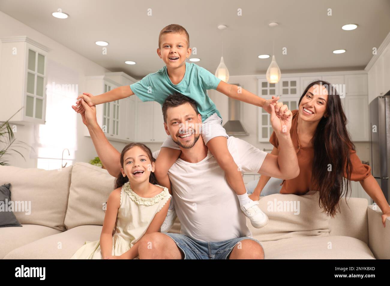 Happy family with children having fun on sofa at home Stock Photo - Alamy