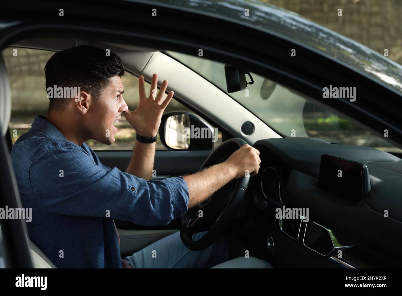 Stressed man in driver's seat of modern car Stock Photo - Alamy