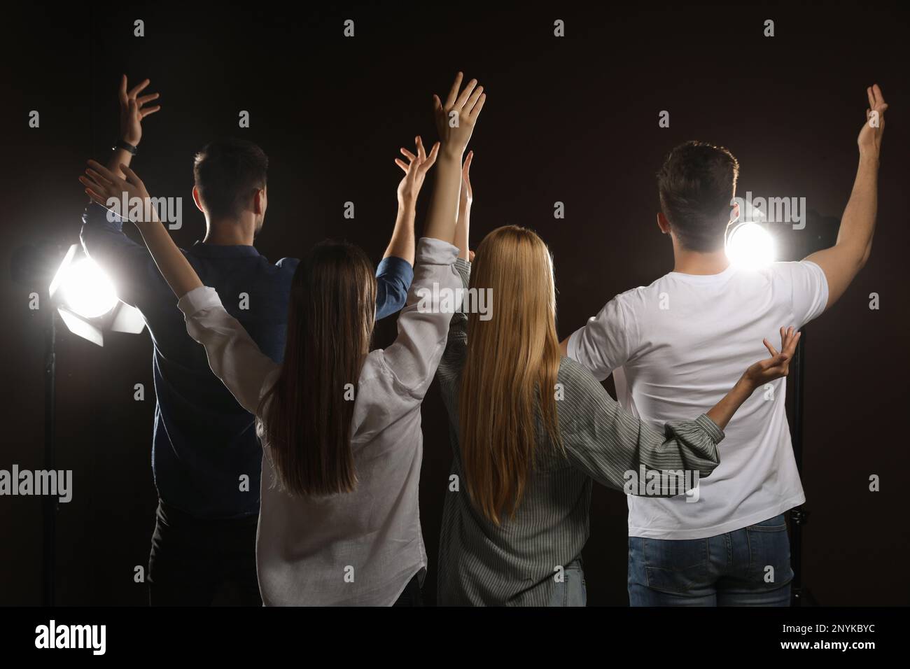 Professional actors bowing on stage in theatre, back view Stock Photo ...
