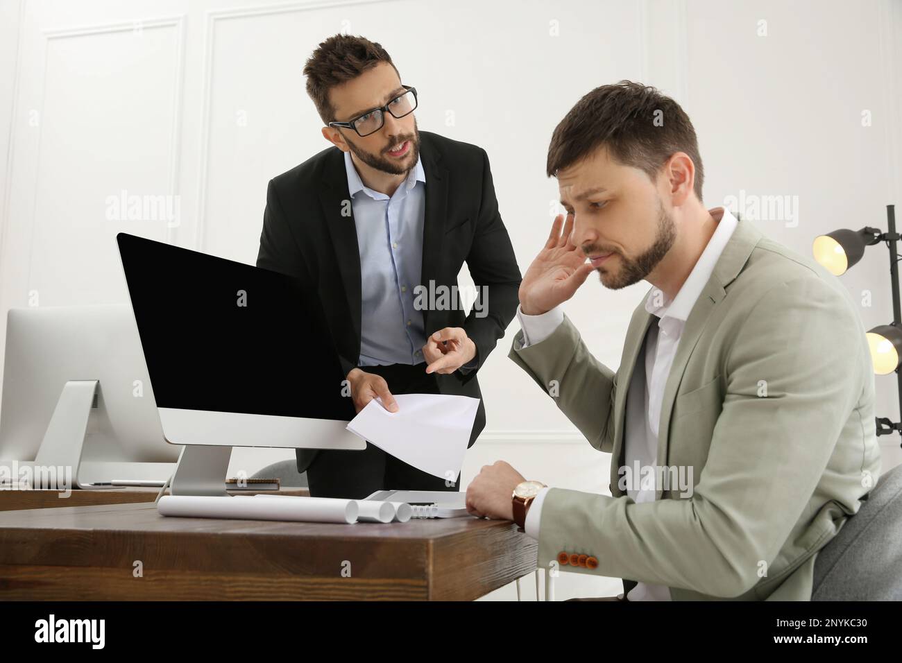 Boss scolding employee in office. Toxic work environment Stock Photo ...