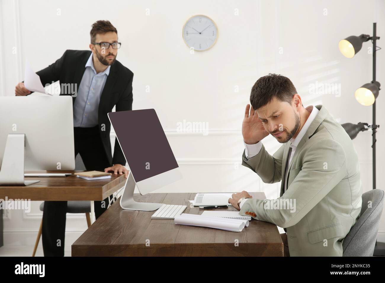 Boss scolding employee in office. Toxic work environment Stock Photo ...