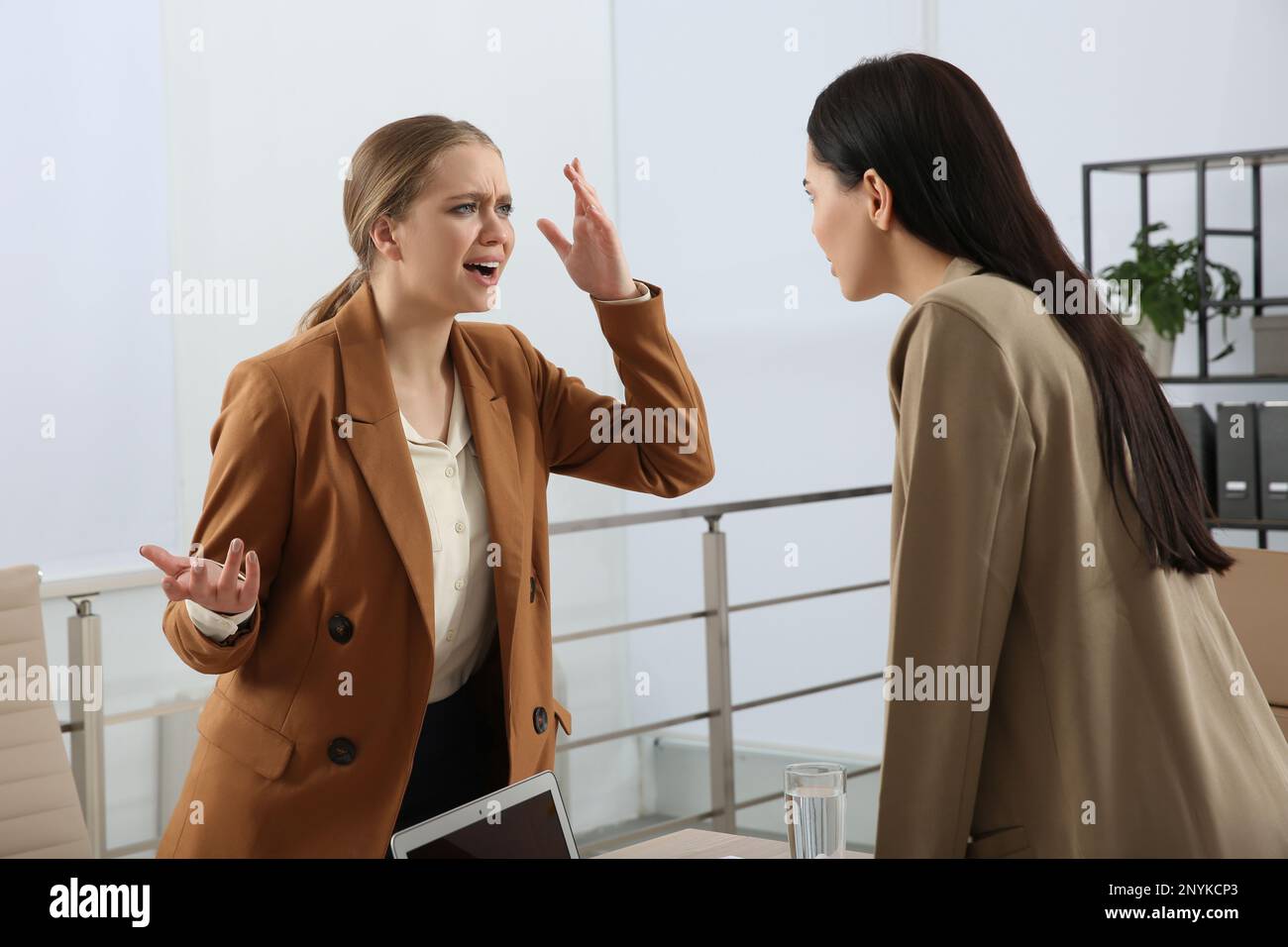 Emotional colleagues arguing in office. Toxic work environment Stock ...