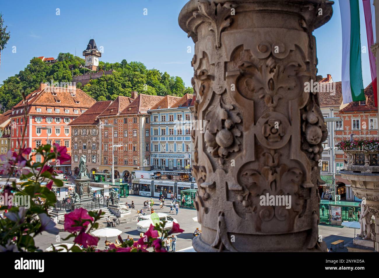 Cityscape with Schlossberg or Castle Hill mountain with old clock tower ...