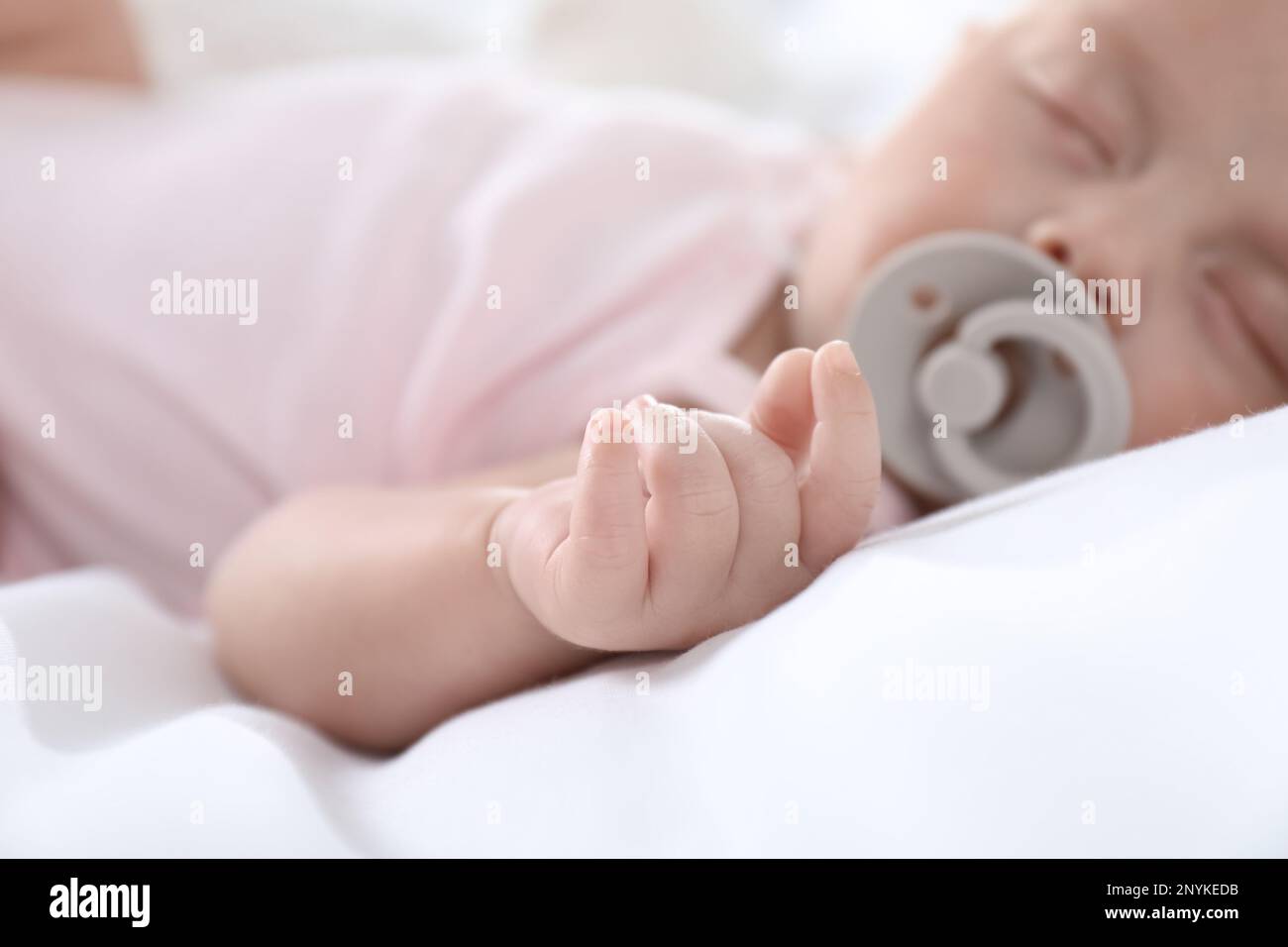 Cute little baby with pacifier sleeping at home, focus on hand Stock ...