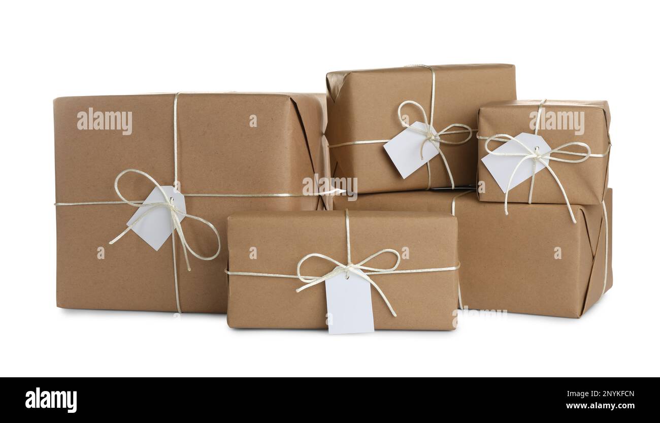 Parcels wrapped in kraft paper with tags on white background Stock ...