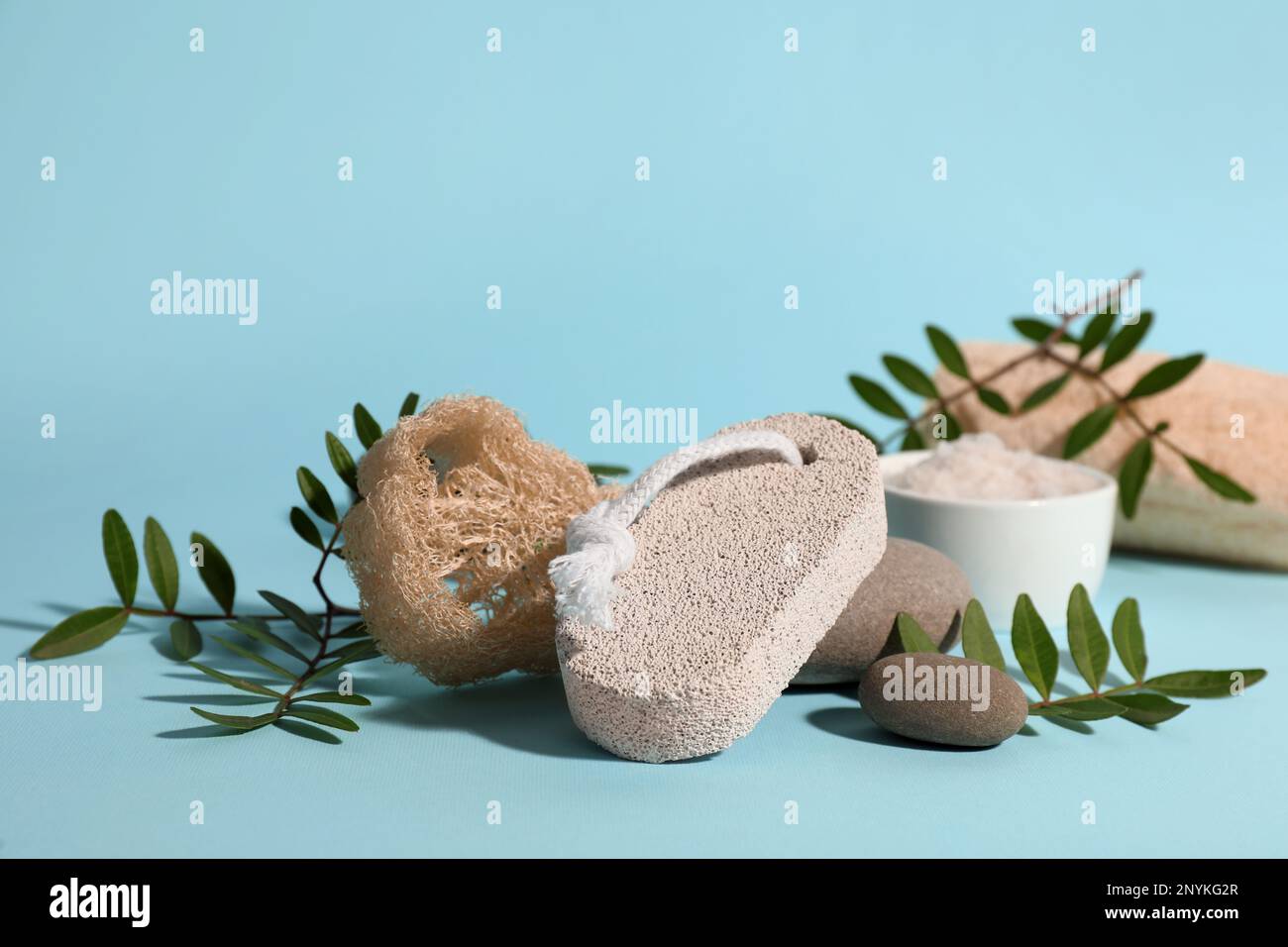 Composition with pumice stone on light blue background Stock Photo - Alamy