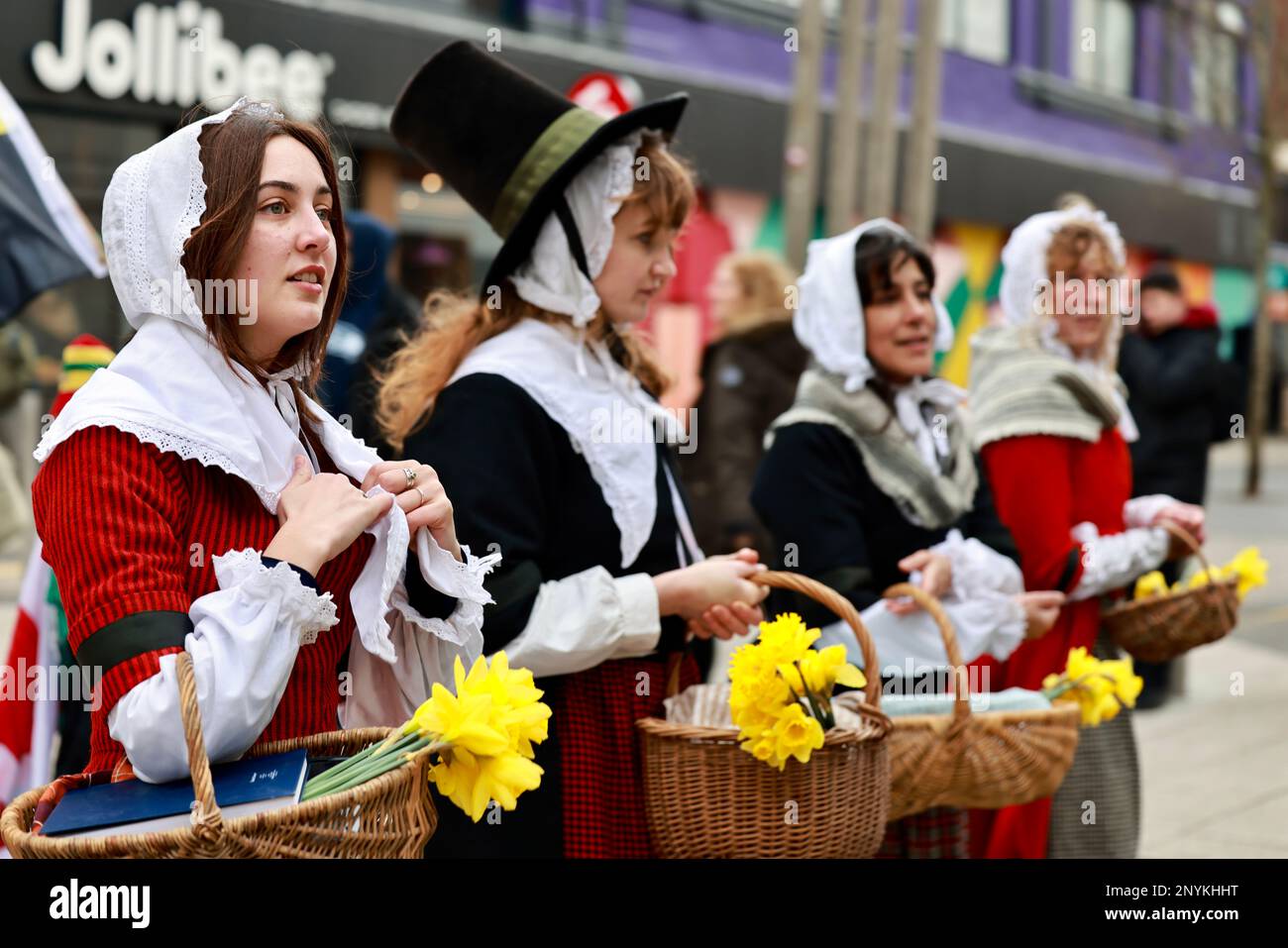 Female participants dressed in traditional Welsh clothing seen holding ...