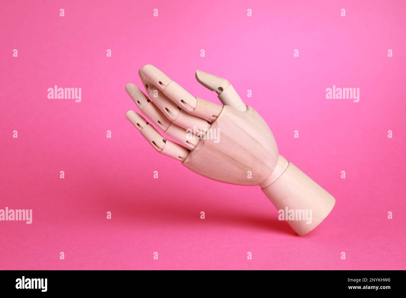 Wooden hand model on pink background. Mannequin part Stock Photo - Alamy