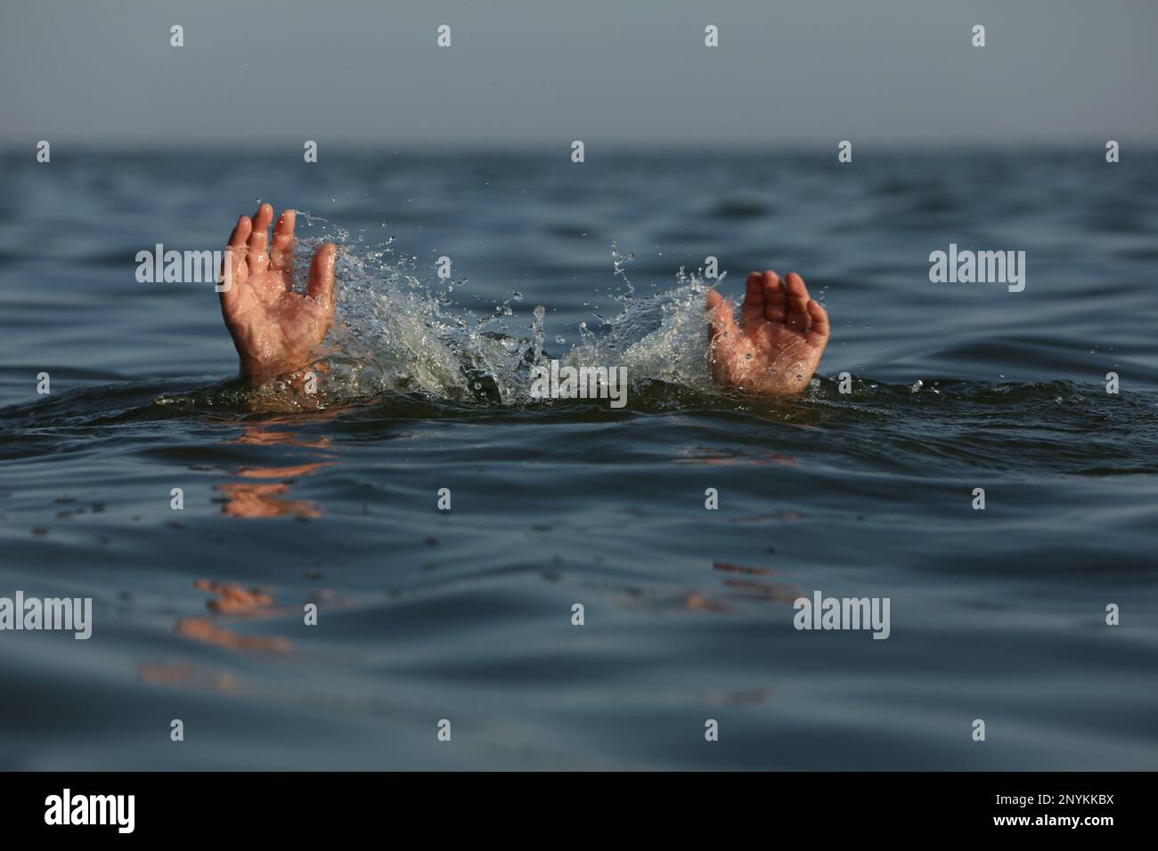 Drowning man reaching for help in sea Stock Photo - Alamy