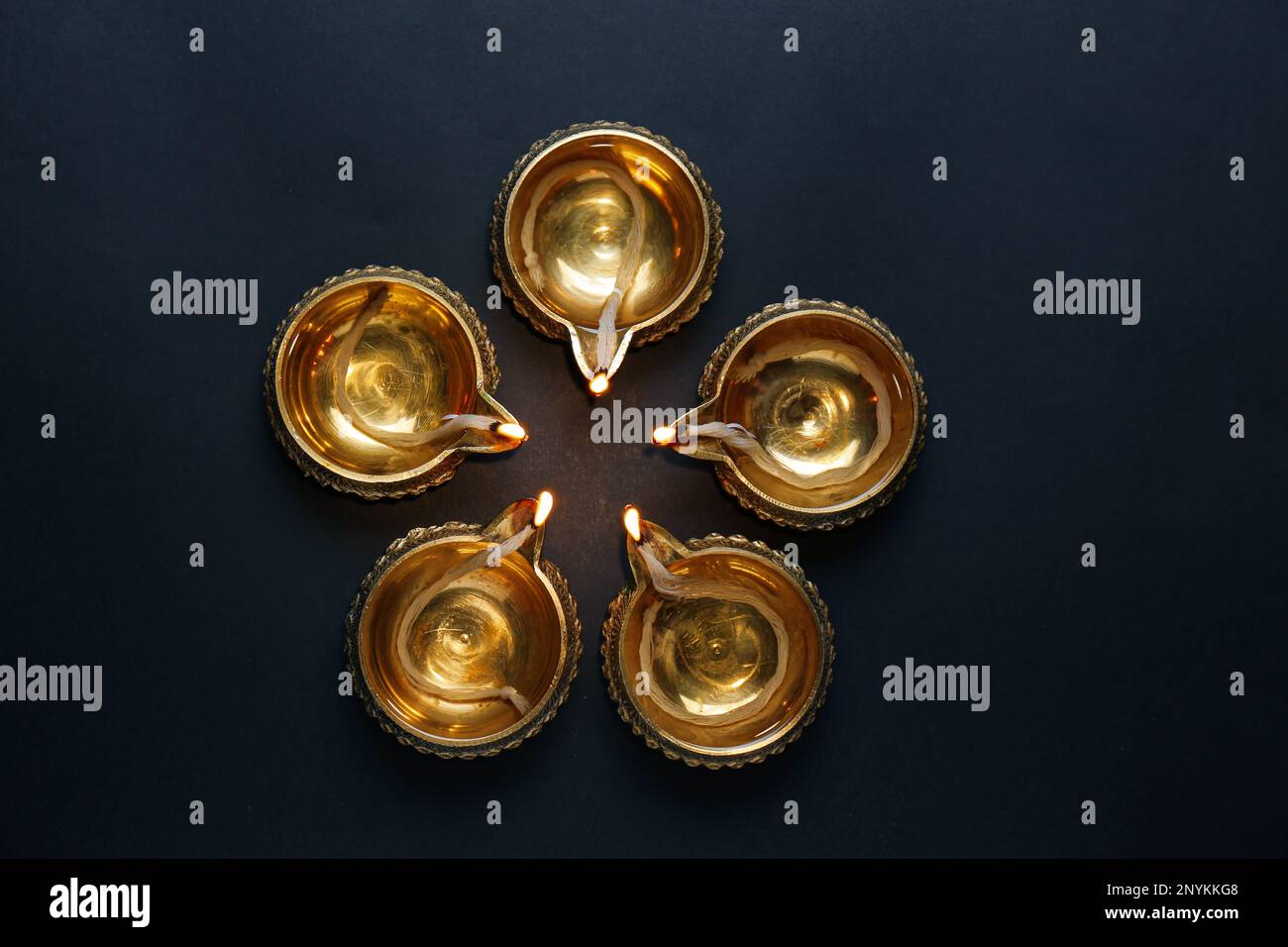 Lit diyas on dark background, flat lay. Diwali lamps Stock Photo - Alamy