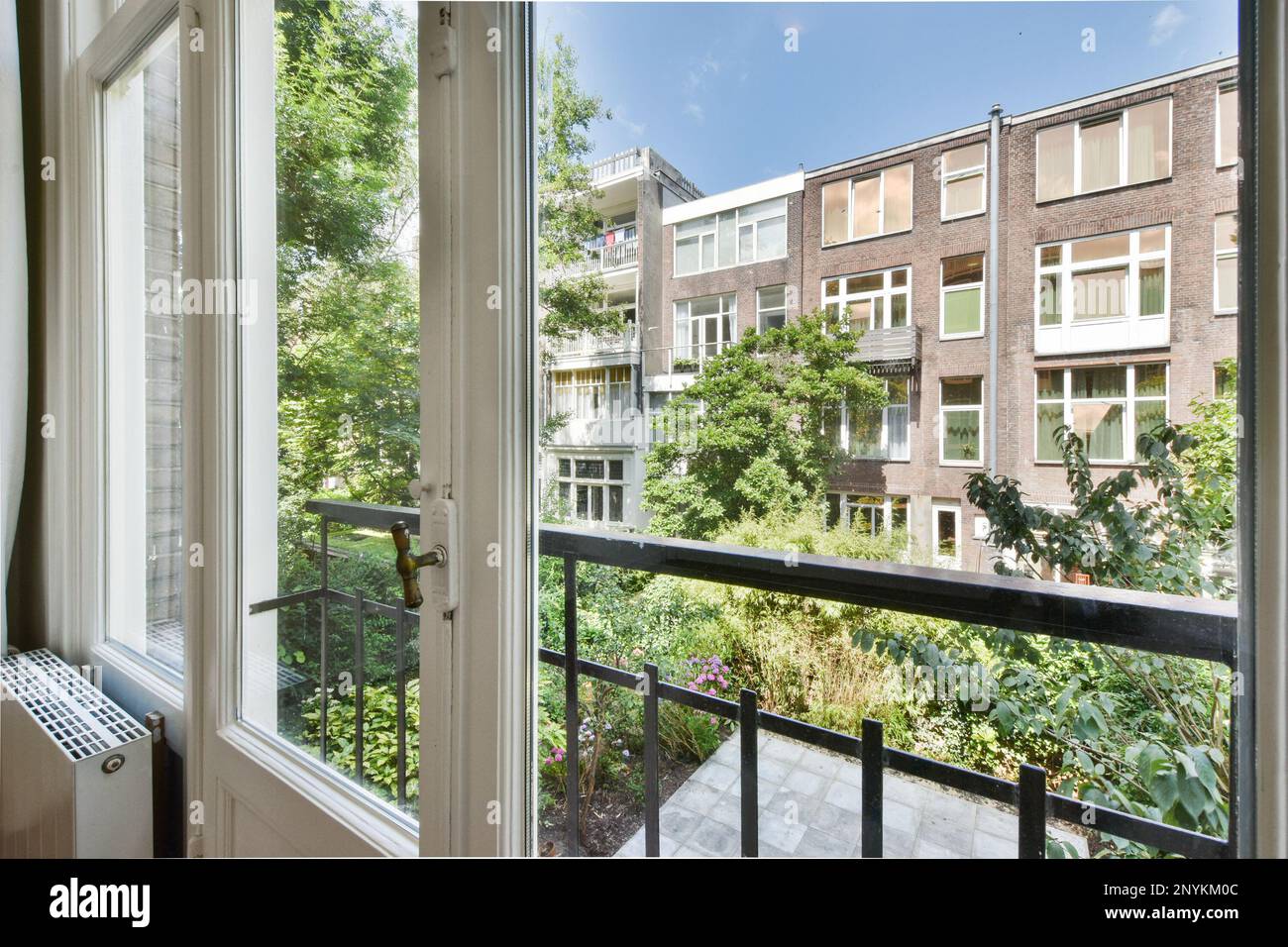 a balcony with plants and buildings in the background, taken from ...