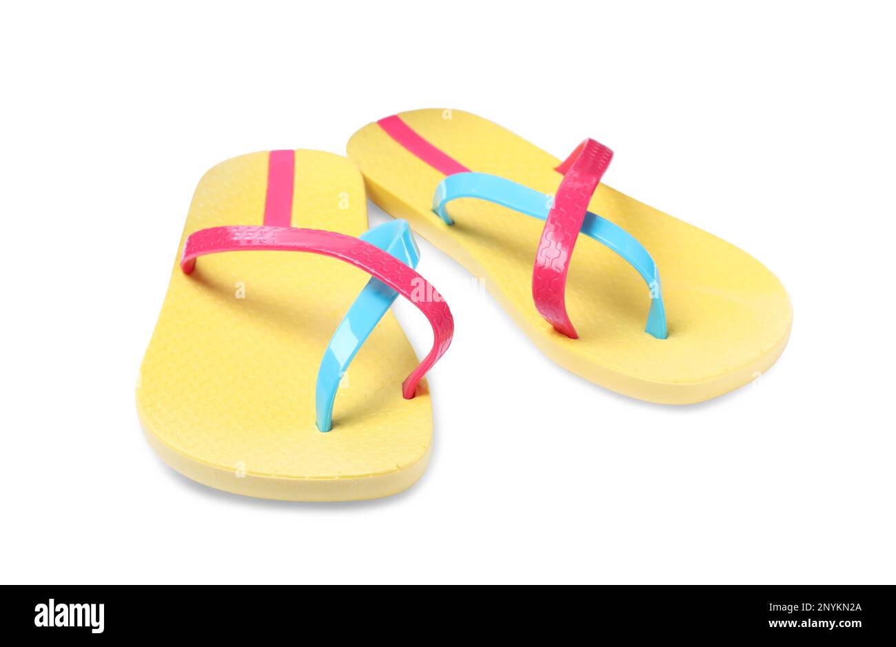 Pair of yellow flip flops isolated on white Stock Photo - Alamy