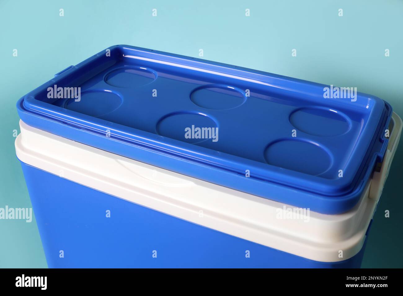 Closed blue plastic cool box on turquoise background, closeup Stock ...