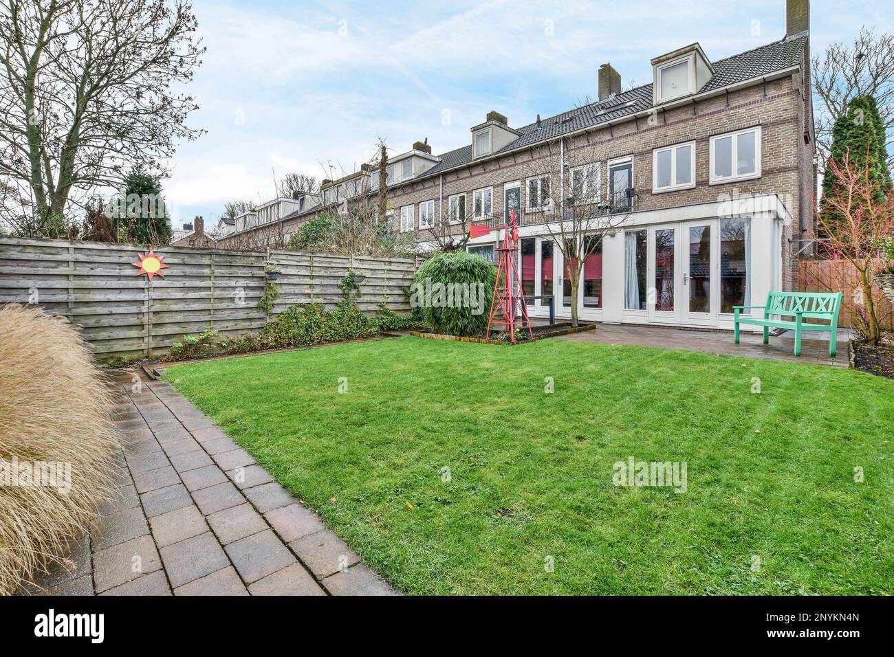 an outside view of a house with green grass and bushes in the front ...