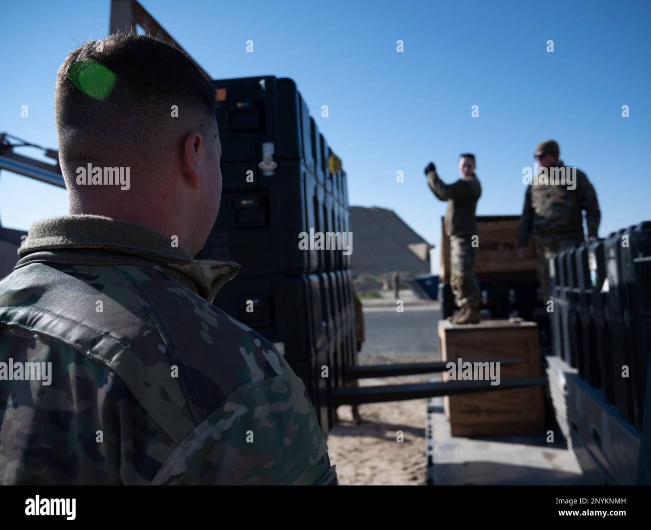 U.S. Army Soldiers from Task Force Rough Riders guide a forklift to ...