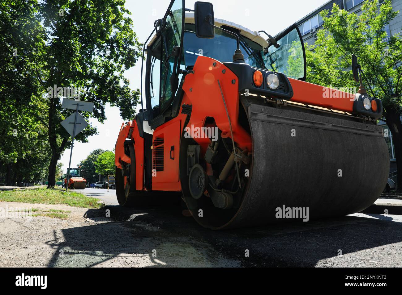 Roller working on city street, low angle view. Road repairing Stock ...