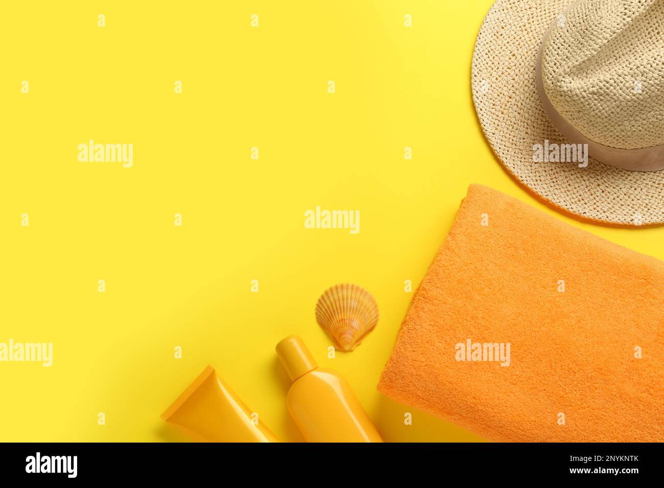 Flat lay composition with different beach objects on yellow background ...