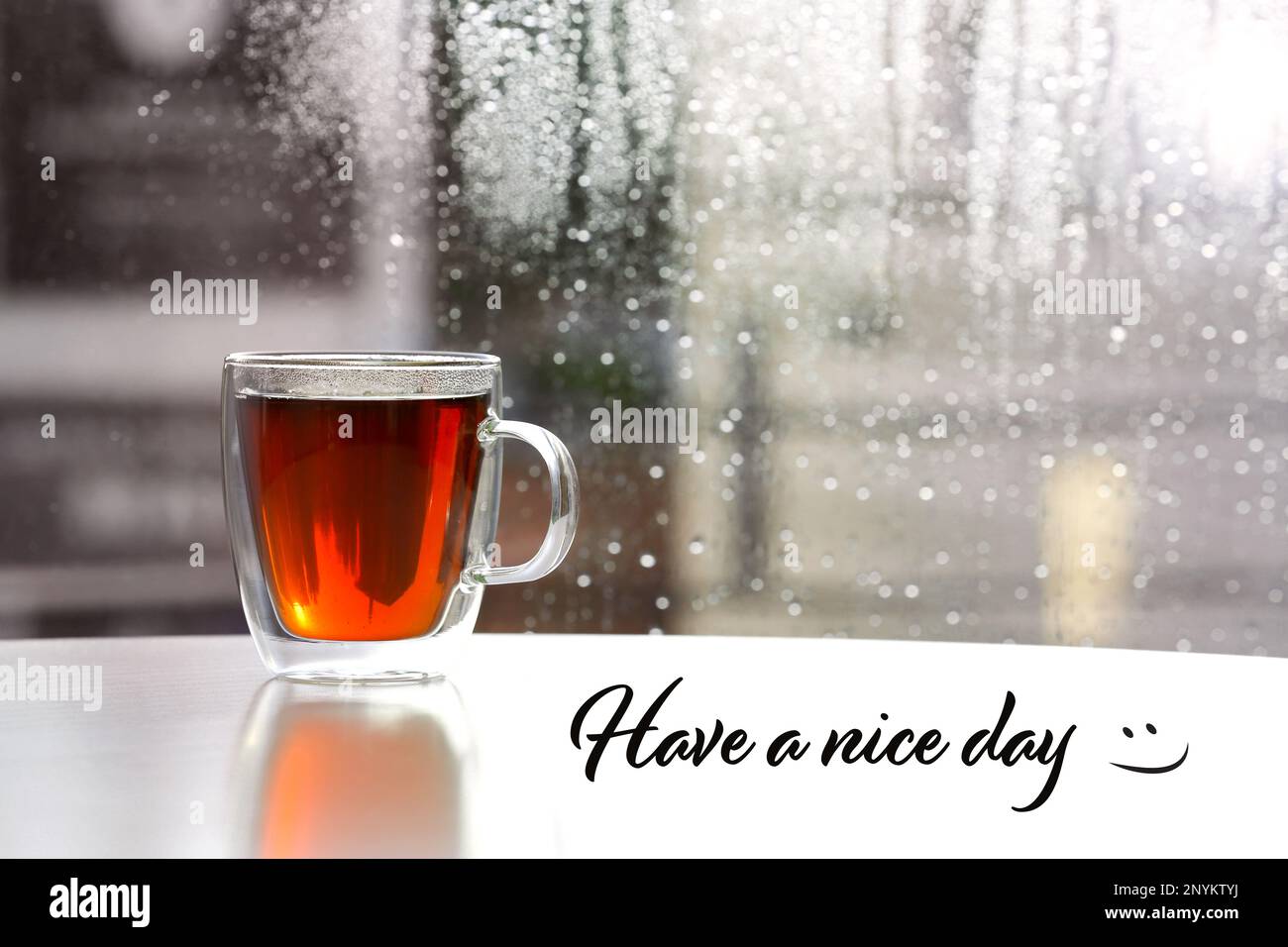 Cup of fresh hot tea on windowsill and text Have a nice day Stock Photo ...