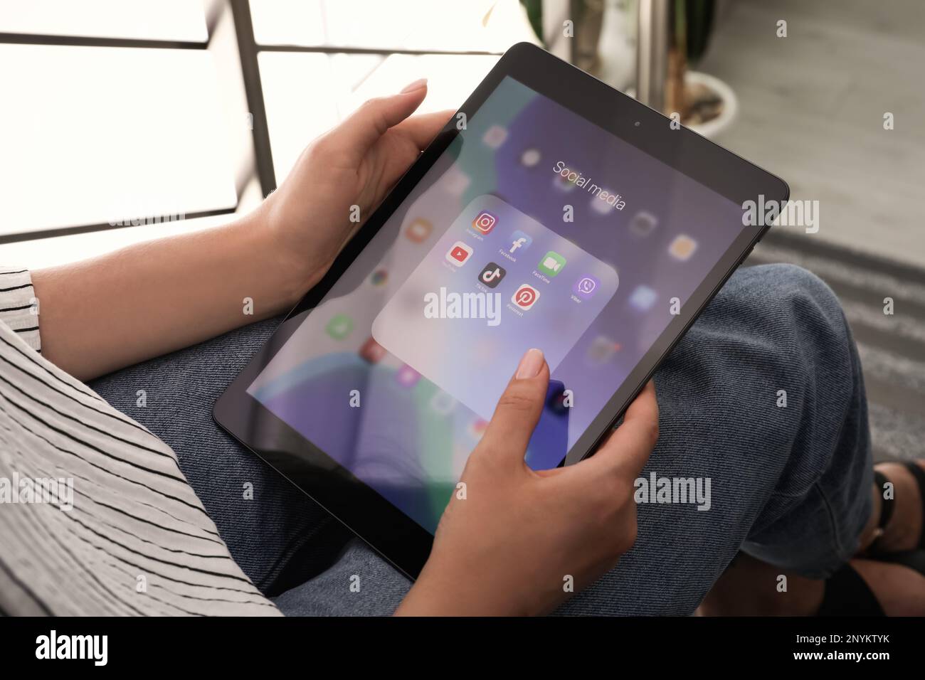 MYKOLAIV, UKRAINE - AUGUST 11, 2021: Woman using tablet indoors ...