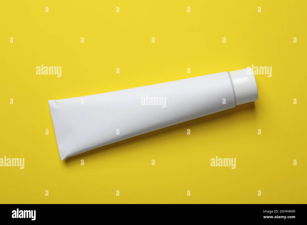 Blank tube of toothpaste on yellow background, top view Stock Photo - Alamy