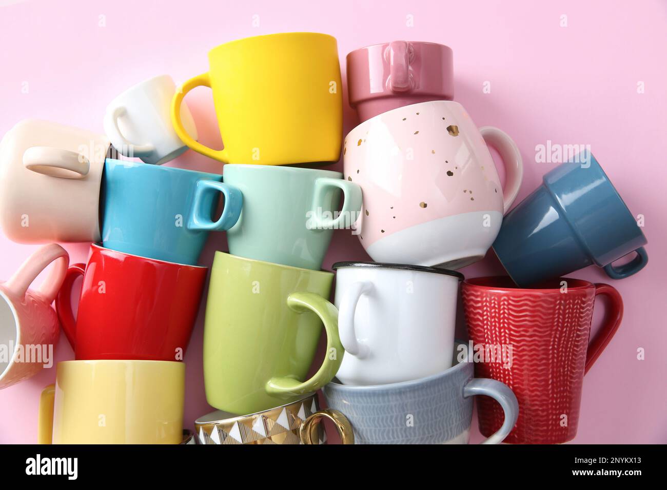 Many different cups on pink background, flat lay. Diversity concept ...