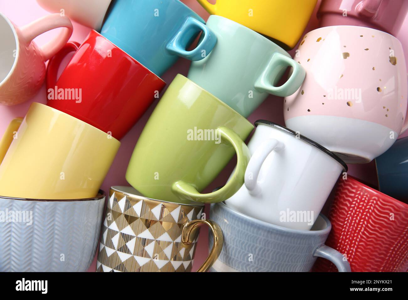 Many different cups on pink background, flat lay. Diversity concept ...